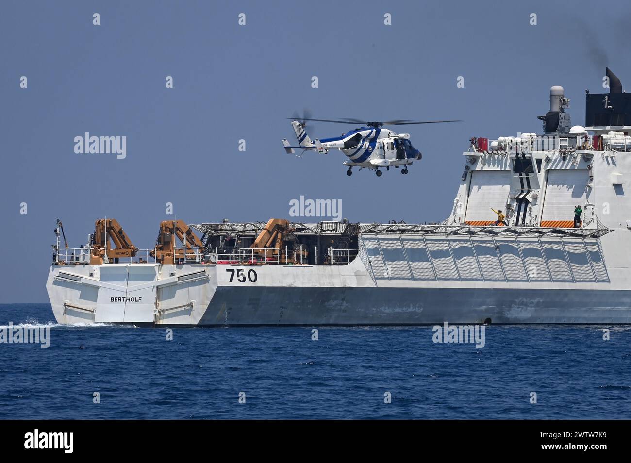 An Indian Coast Guard helicopter hovers above the flight deck of U.S ...