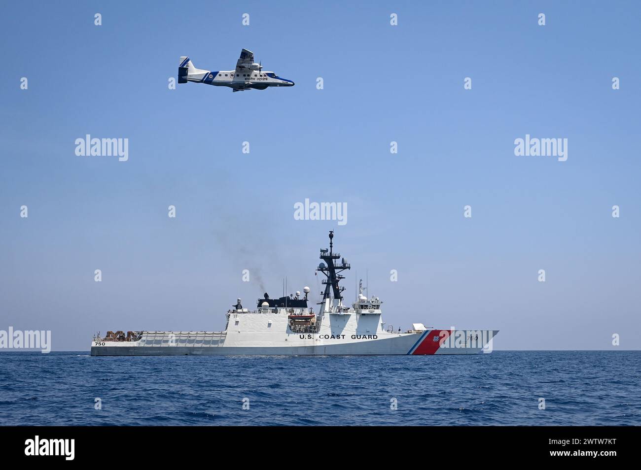 An Indian Coast Guard fixed-wing aircraft flies above U.S. Coast Guard ...