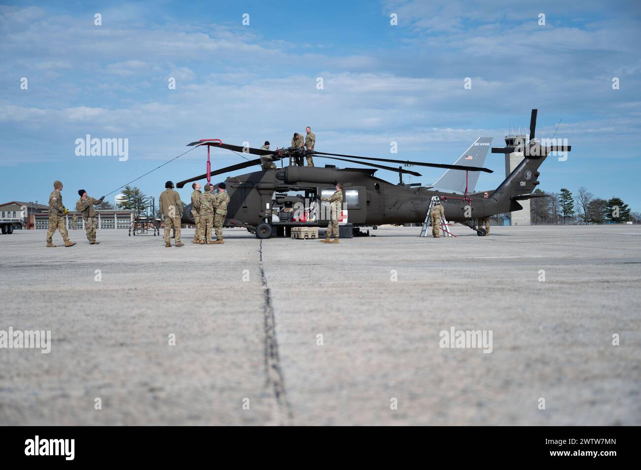 Soldiers with the 238th Medevac Company finish folding the blades of an ...