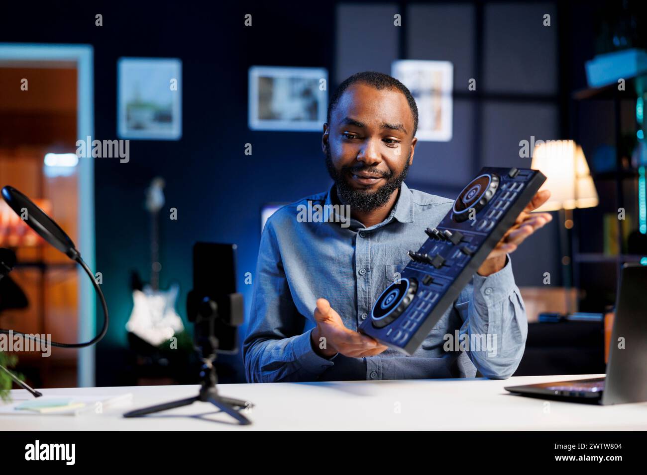 Internet show host mixing on DJ turntables, doing music production ...