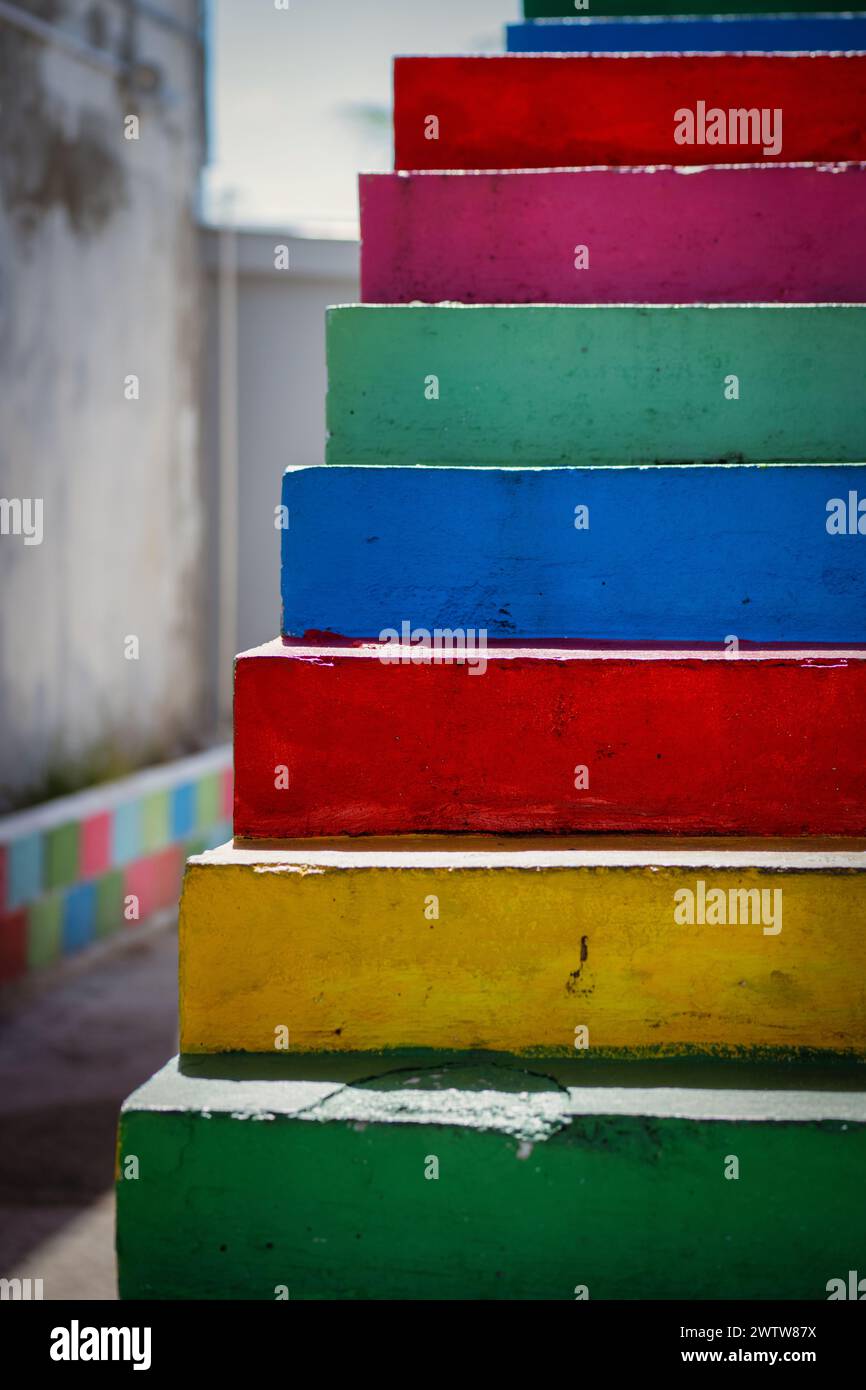 A close-up of a staircase with brightly painted steps in the colors of ...