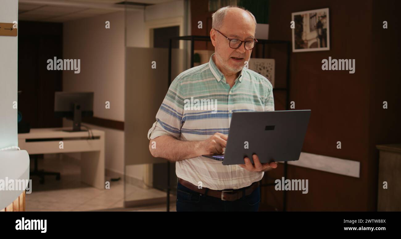 Older person searching for places to visit on laptop, using wireless ...
