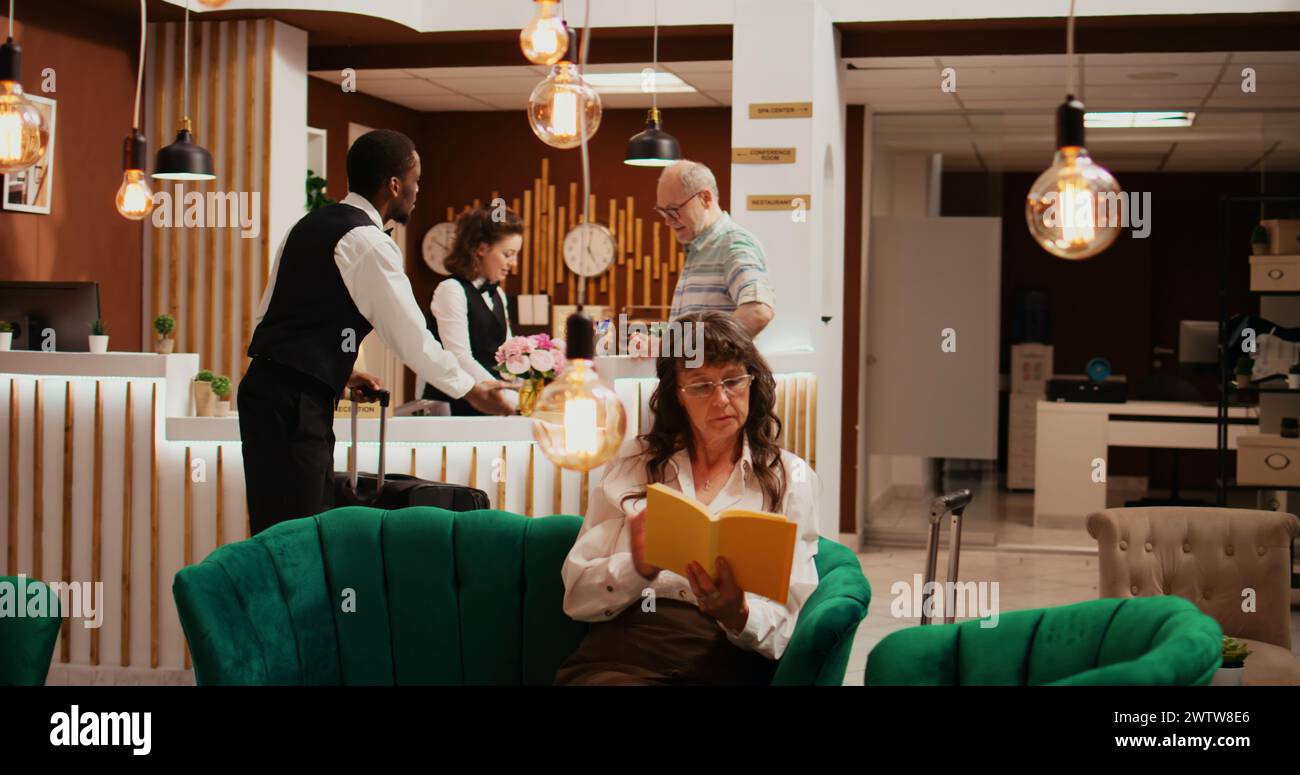 Receptionist gives access key card to hotel guest, finishing with check ...