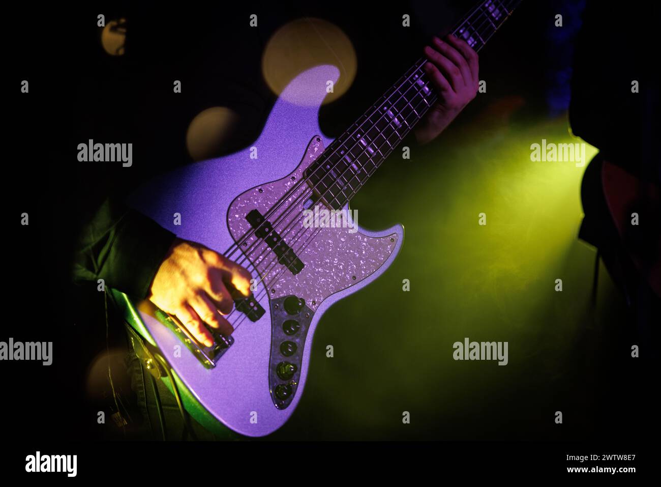Bass guitarist playing live concert with rock band Stock Photo - Alamy