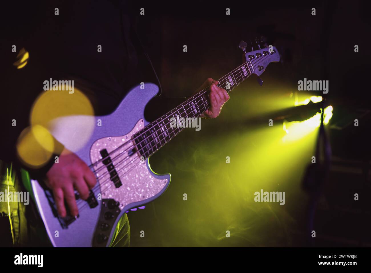 Bass guitarist playing live concert with rock band Stock Photo - Alamy
