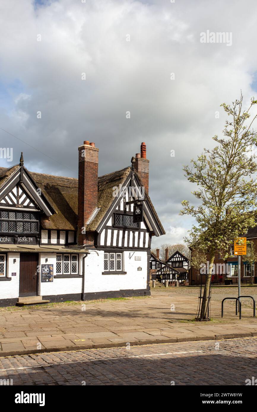 Black and white half timbered thatched roof coaching inn the Black Bear ...