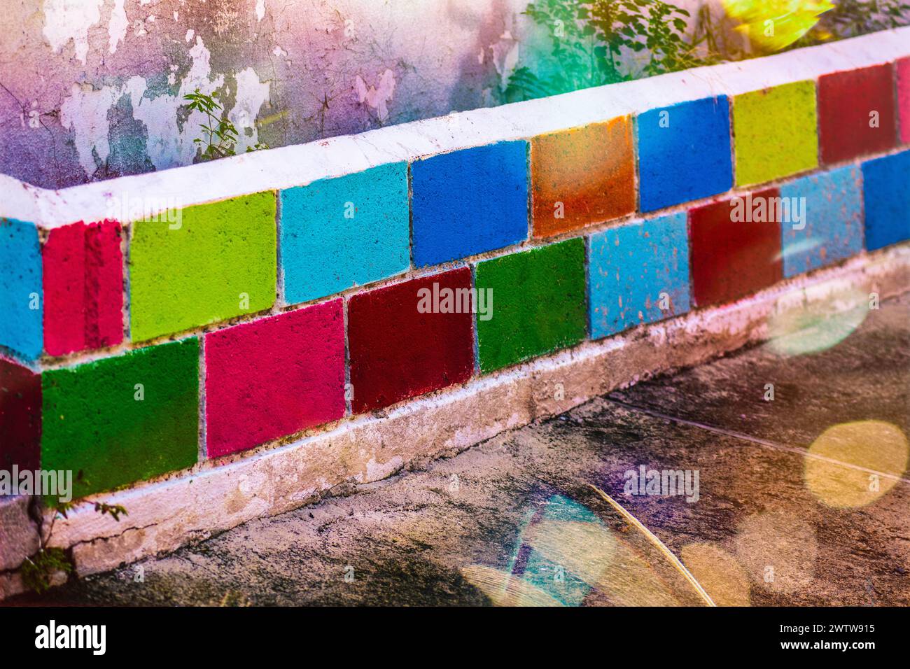 A vivid, colorful wall and pavement decorated with squares of different ...