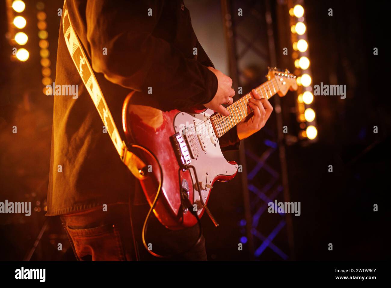 An intimate moment of a live performance captured, as a guitarist plays ...
