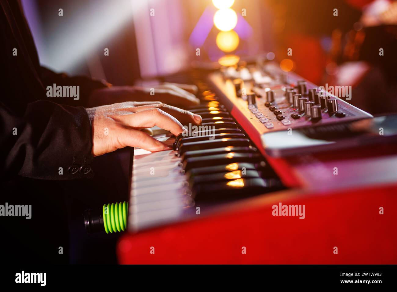 Musician hands on the modern piano keyboard keys, side view Stock Photo ...