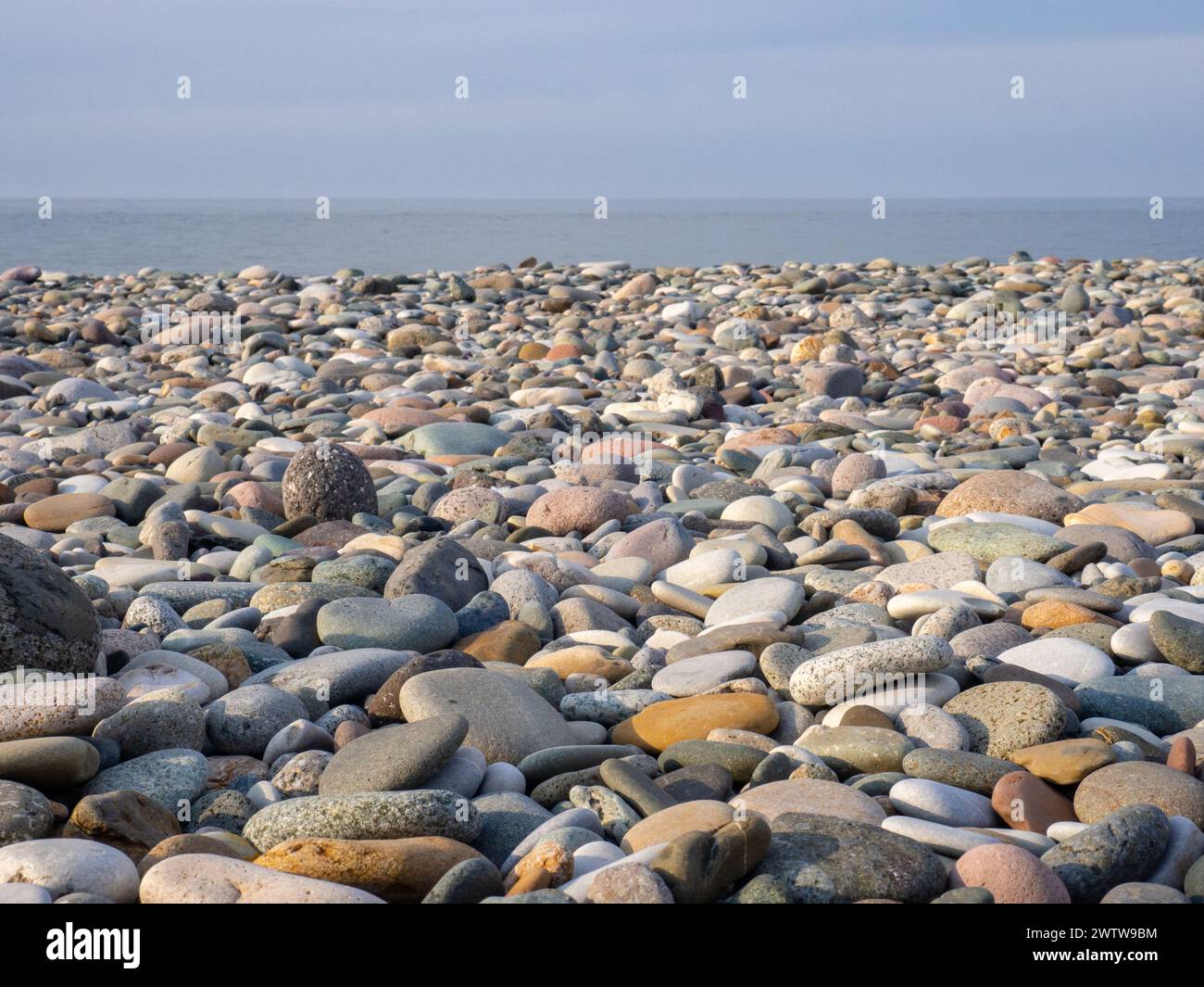 Gray sand and stones close-up on the beach. Beach in winter. Sea coast ...