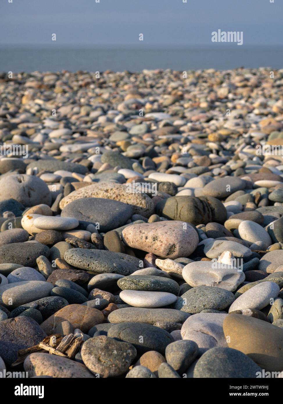 Gray sand and stones on the beach. Beach in winter. Sea coast soil ...