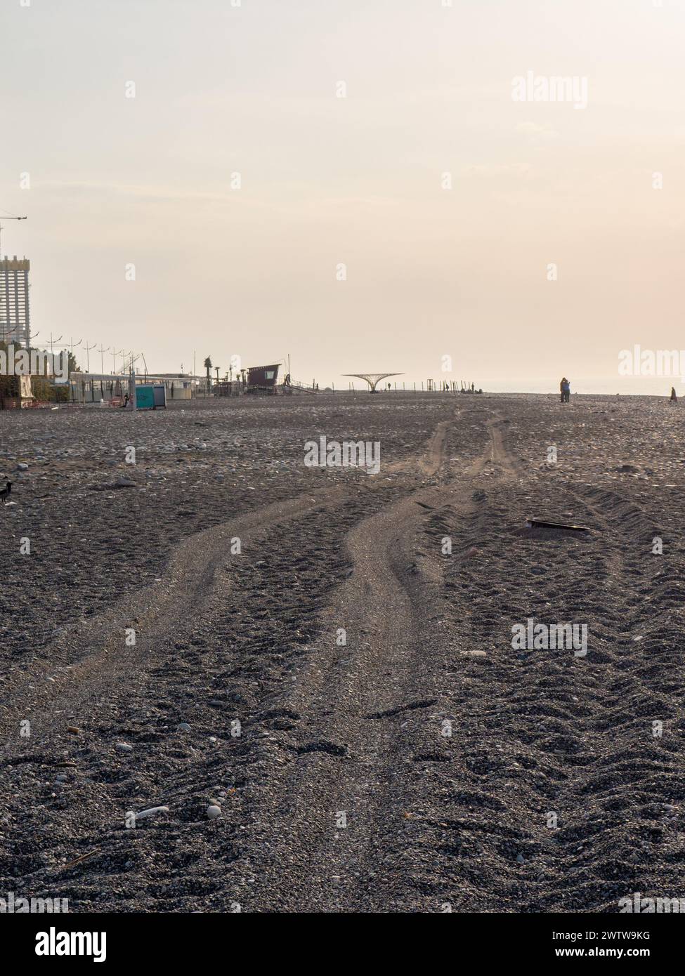 Rut in the sand. Tracks from car wheels on the beach. Sand and stones ...