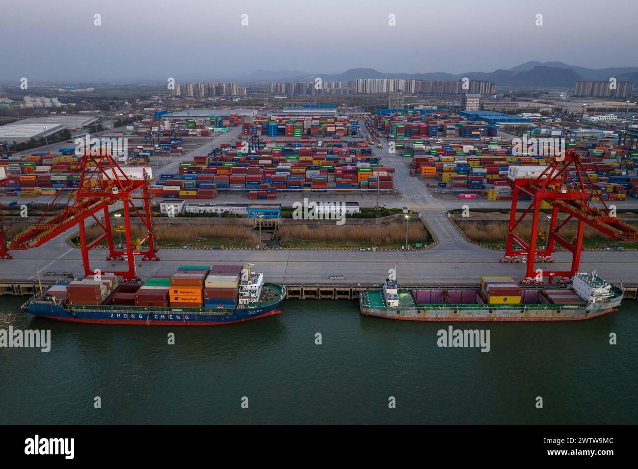 NANJING, CHINA - MARCH 19, 2024 - Cargo ships dock at the container ...