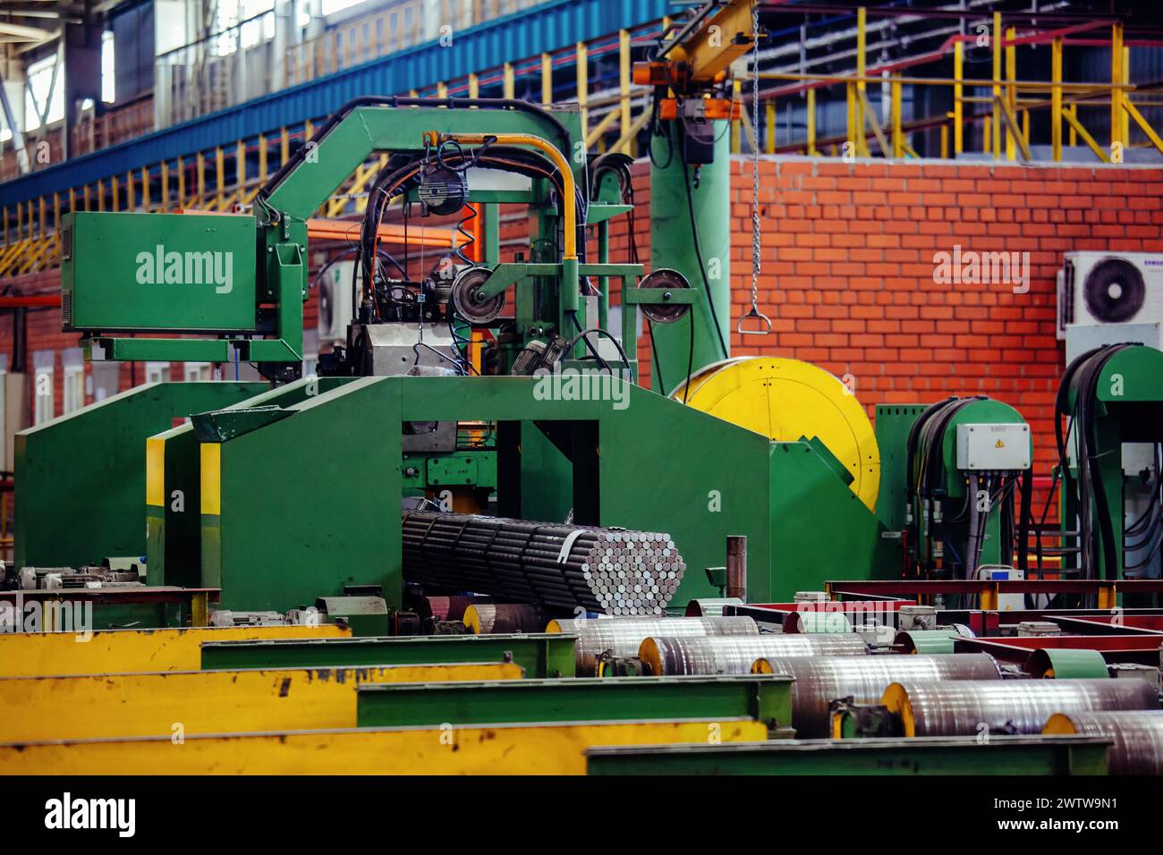 Packs of rolled metal bars on roller conveyor Stock Photo - Alamy