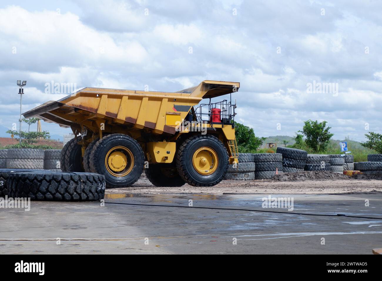 Big yellow mining truck parked at the workshop Stock Photo - Alamy