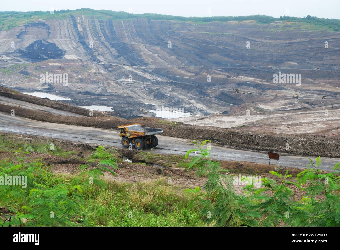 mining truck in an open pit at coal mining or quarry Stock Photo - Alamy