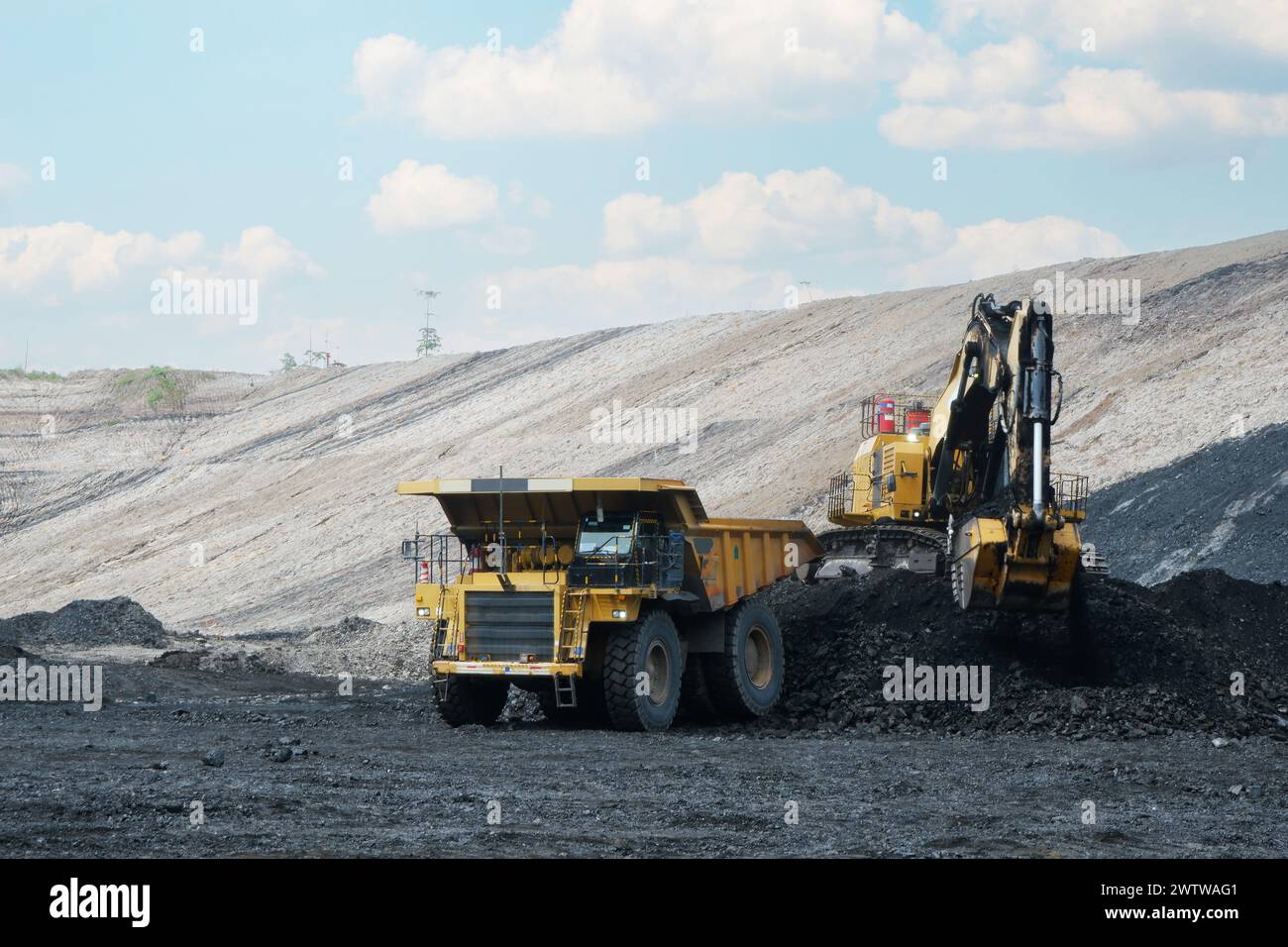 Large mine dump truck and excavator. heavy equipment loading coal in ...