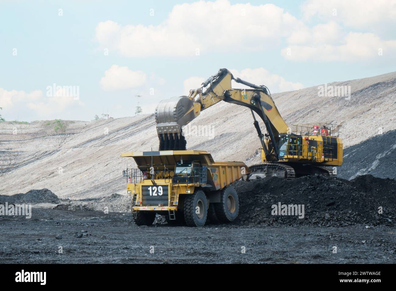 coal loading from excavator into truck, coal mine industry Stock Photo - Alamy