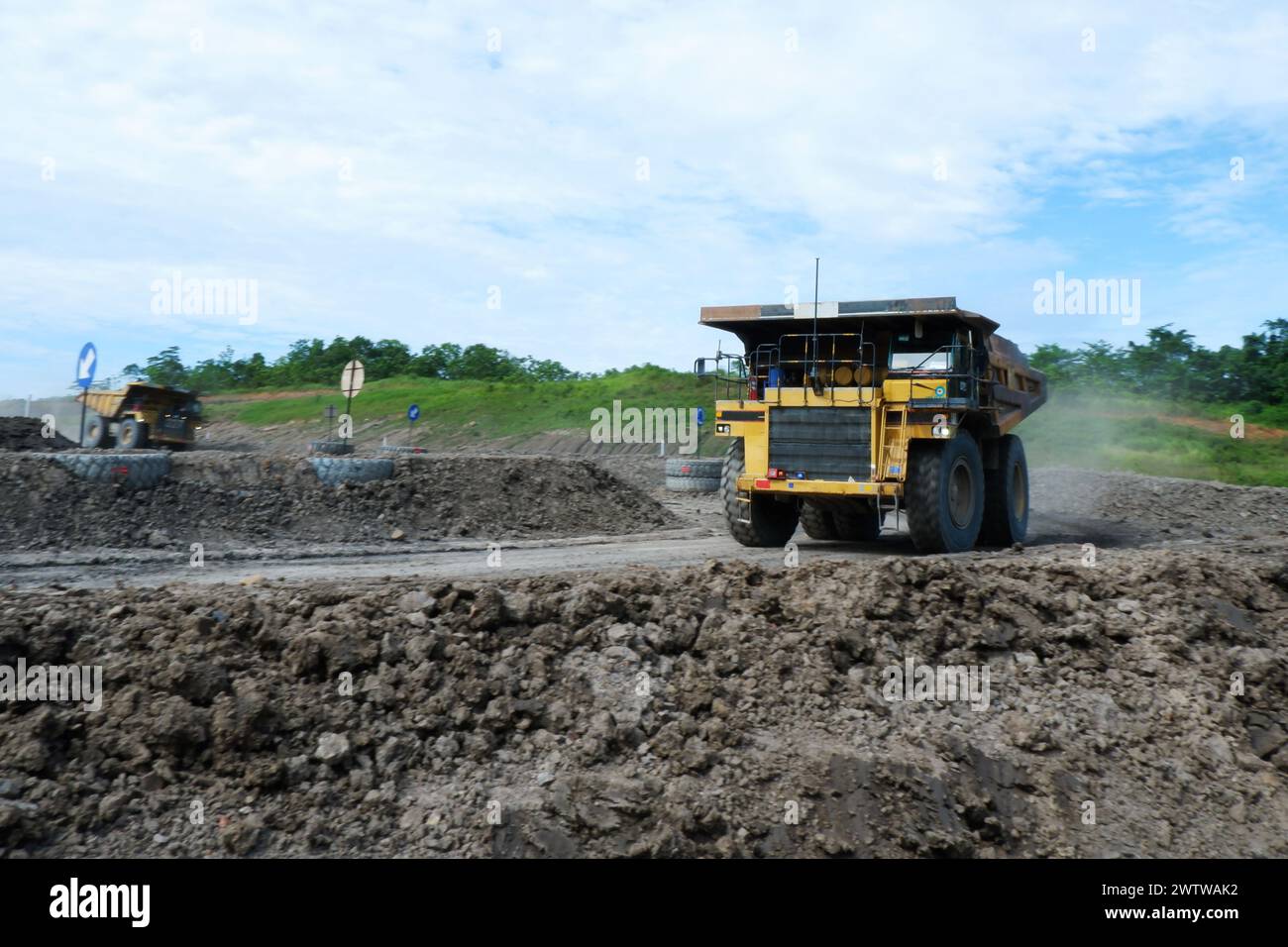 big yellow truck transporting coal from quarry. coal mine industry ...