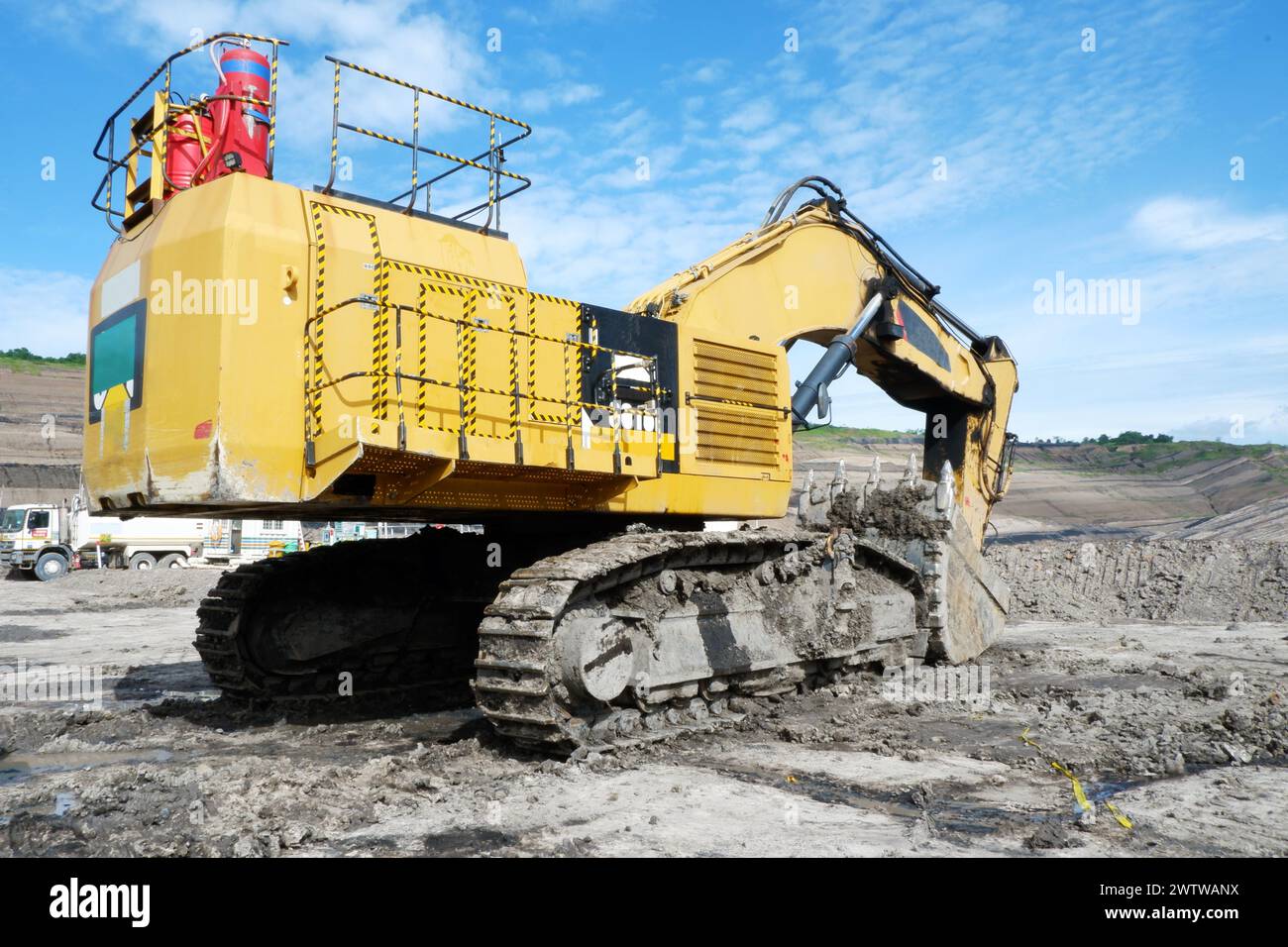 big yellow excavator or digger for coal ore in mining site at borneo ...