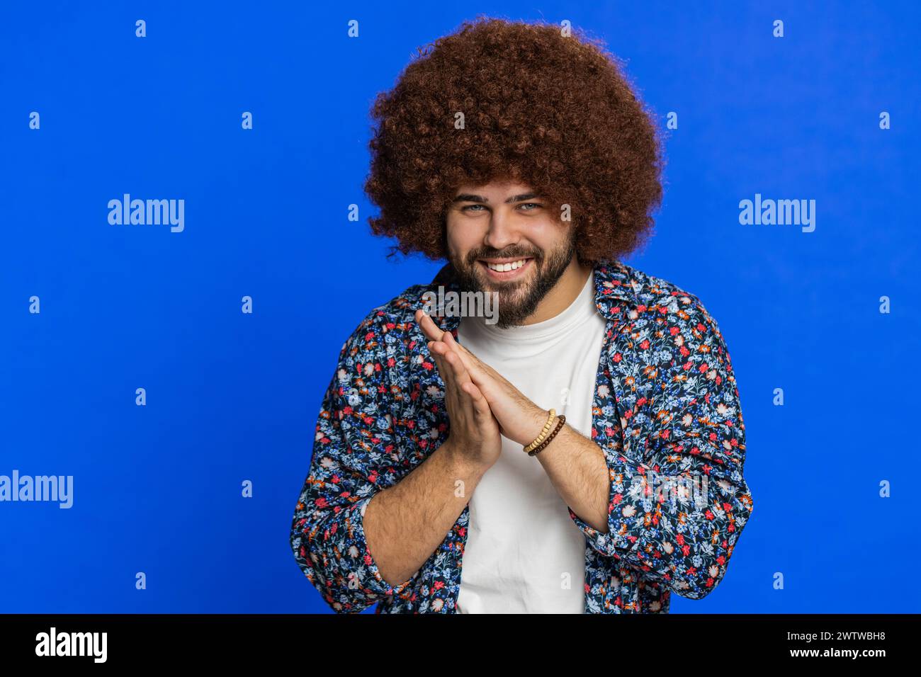 Sneaky cunning young man with Afro hairstyle wig with tricky face ...
