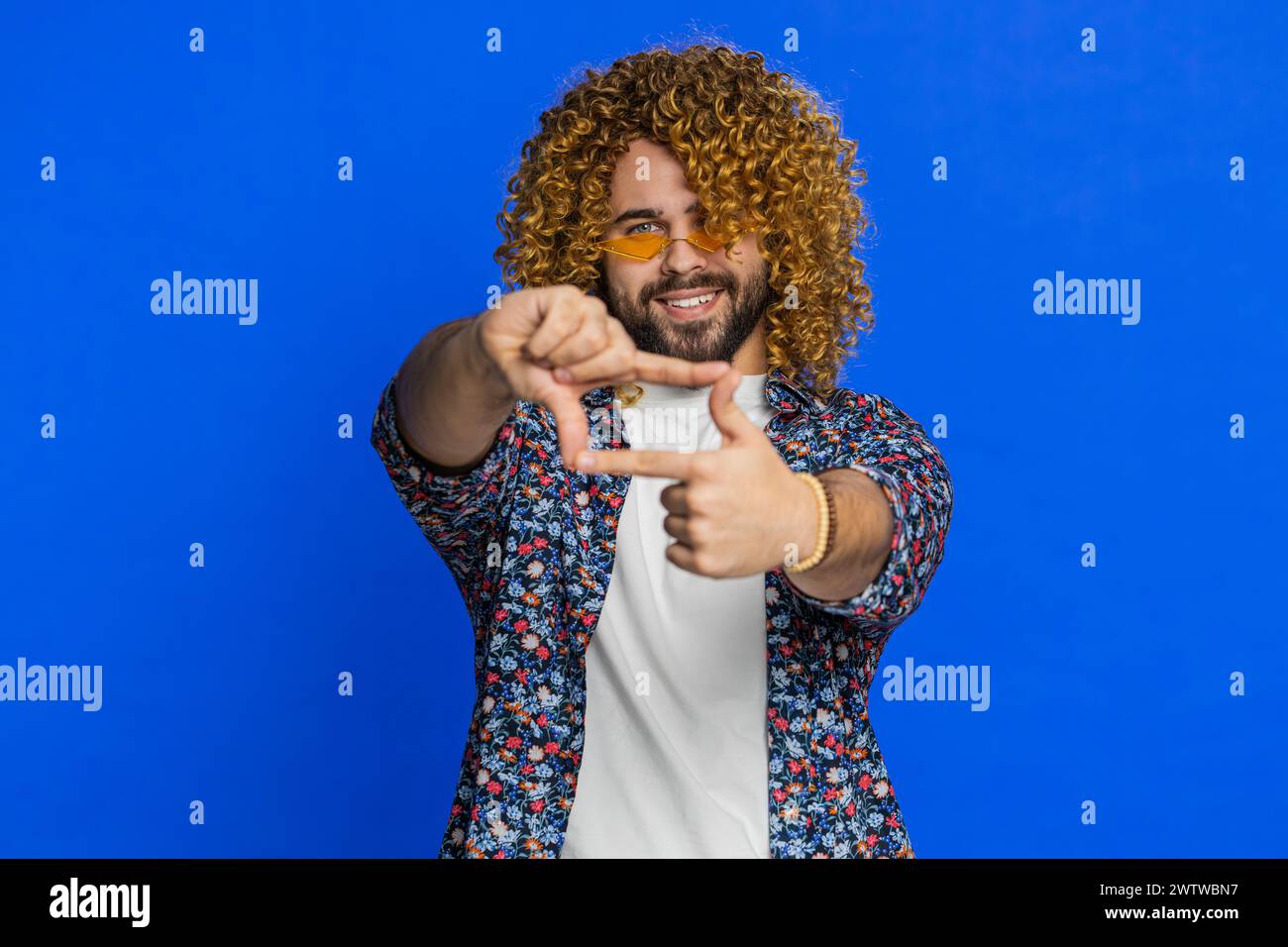 Caucasian man photographer gesturing picture frame with hands, looks ...