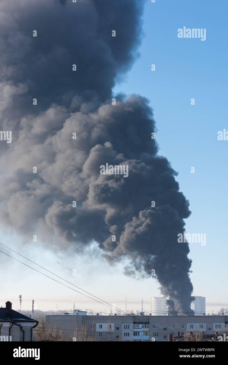 Smoke from the explosion above the houses vertical Stock Photo - Alamy
