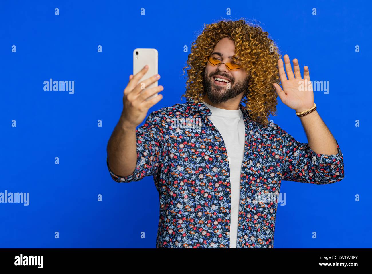 Happy stylish man tourist with curly hairstyle wig blogger taking ...