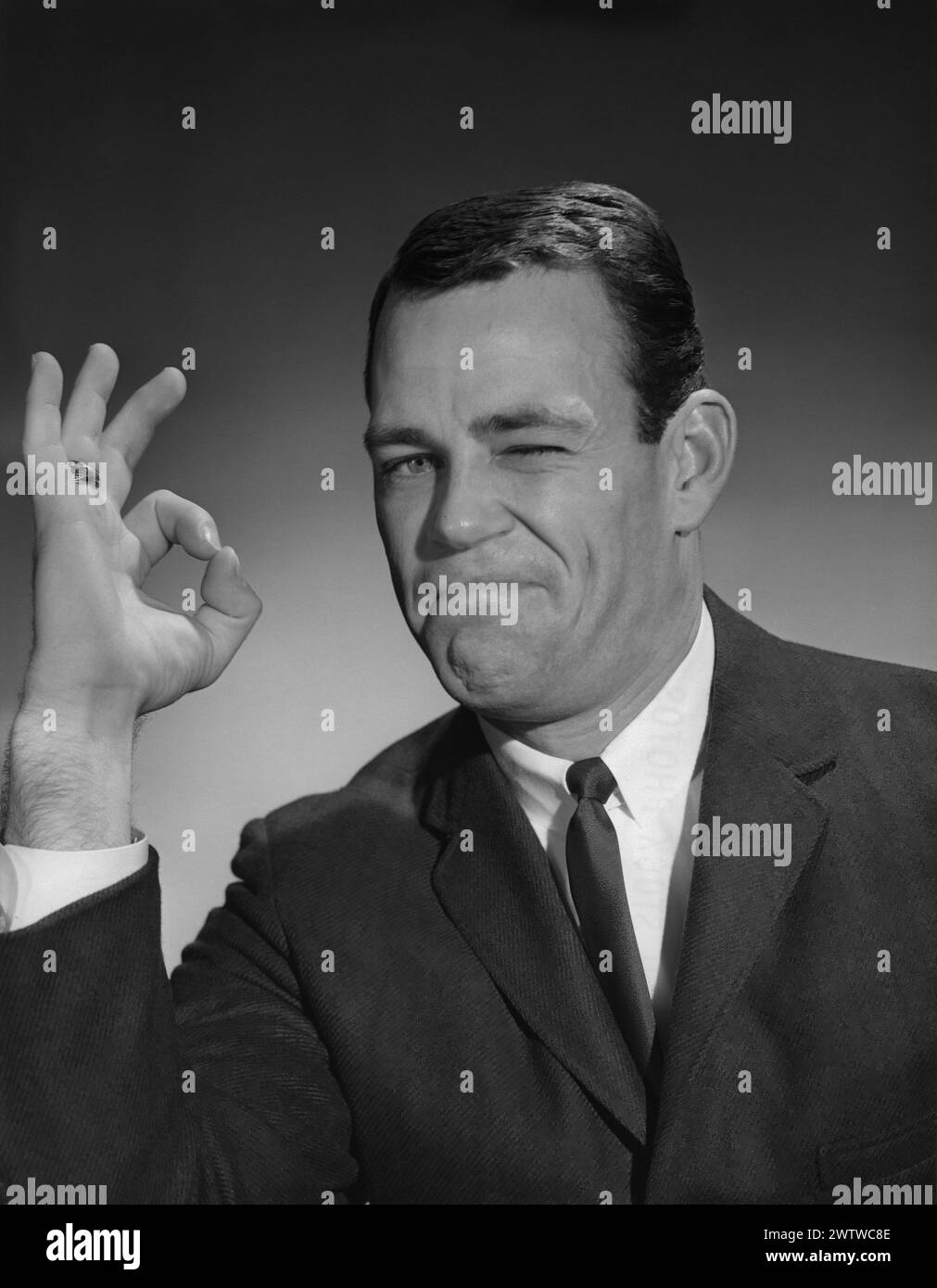 Young businessman in a suit and tie, clean-cut looking at the camera ...
