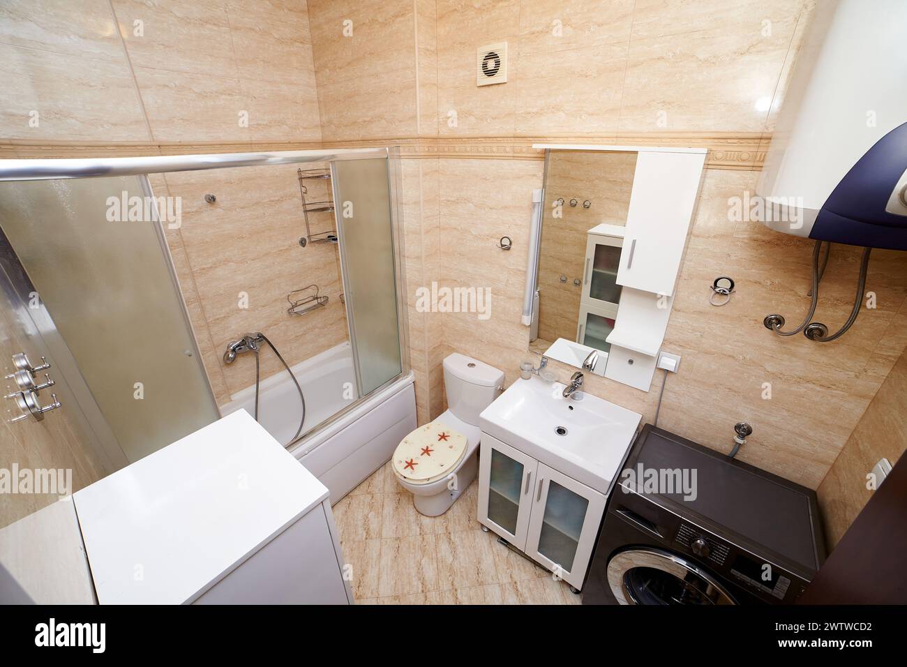 Shower cabin in the bath next to the toilet, washbasin, washing machine ...