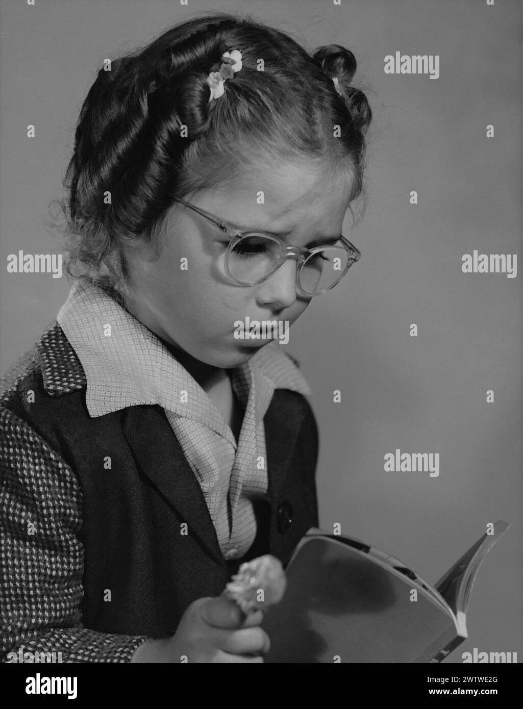 A young girl appears involved in the book she is reading Stock Photo ...