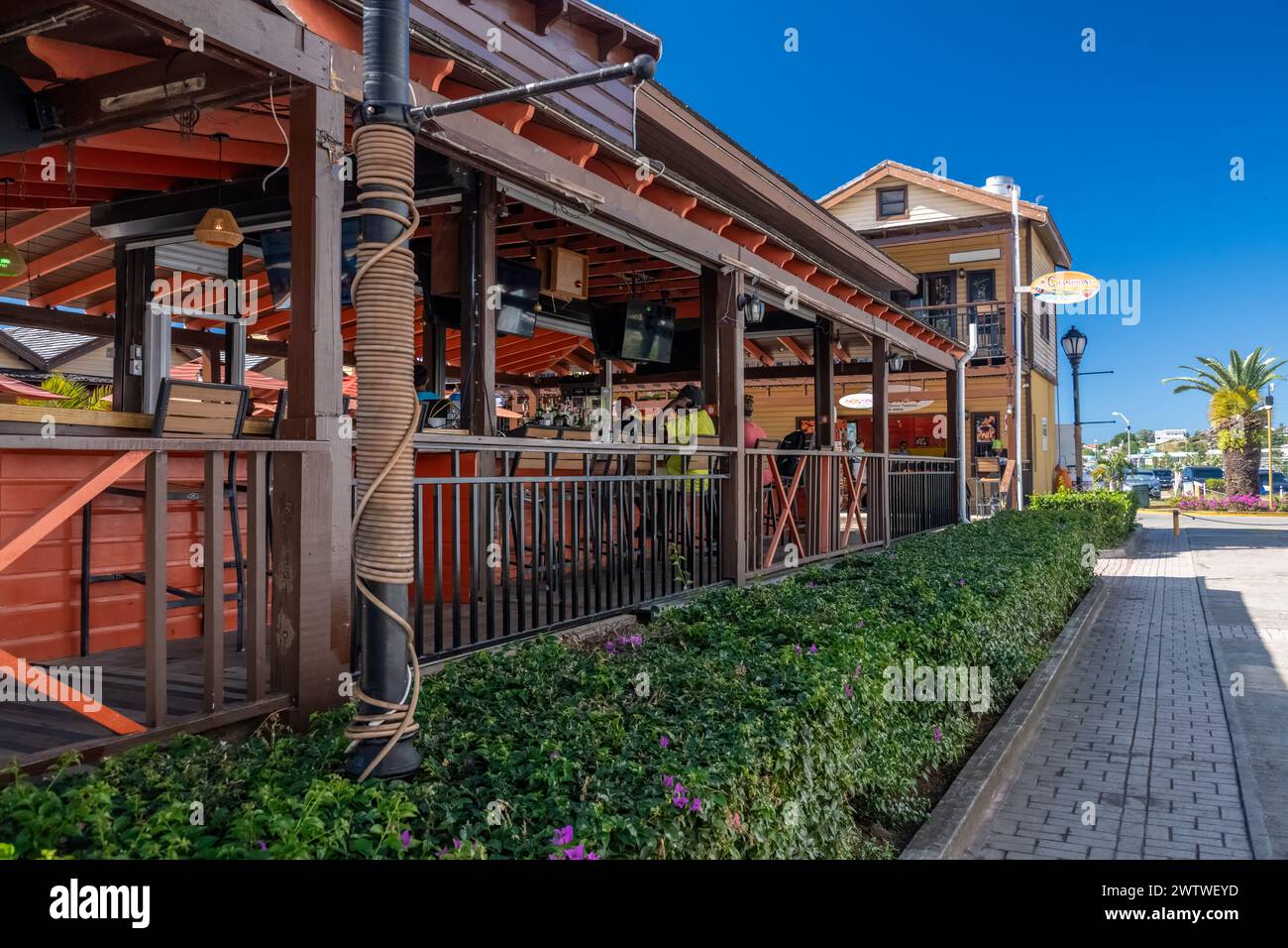 An inviting restaurant with wooden exterior and open-air seating ...