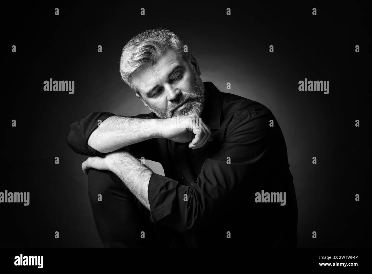 Portrait of handsome man on dark background. Black and white effect ...