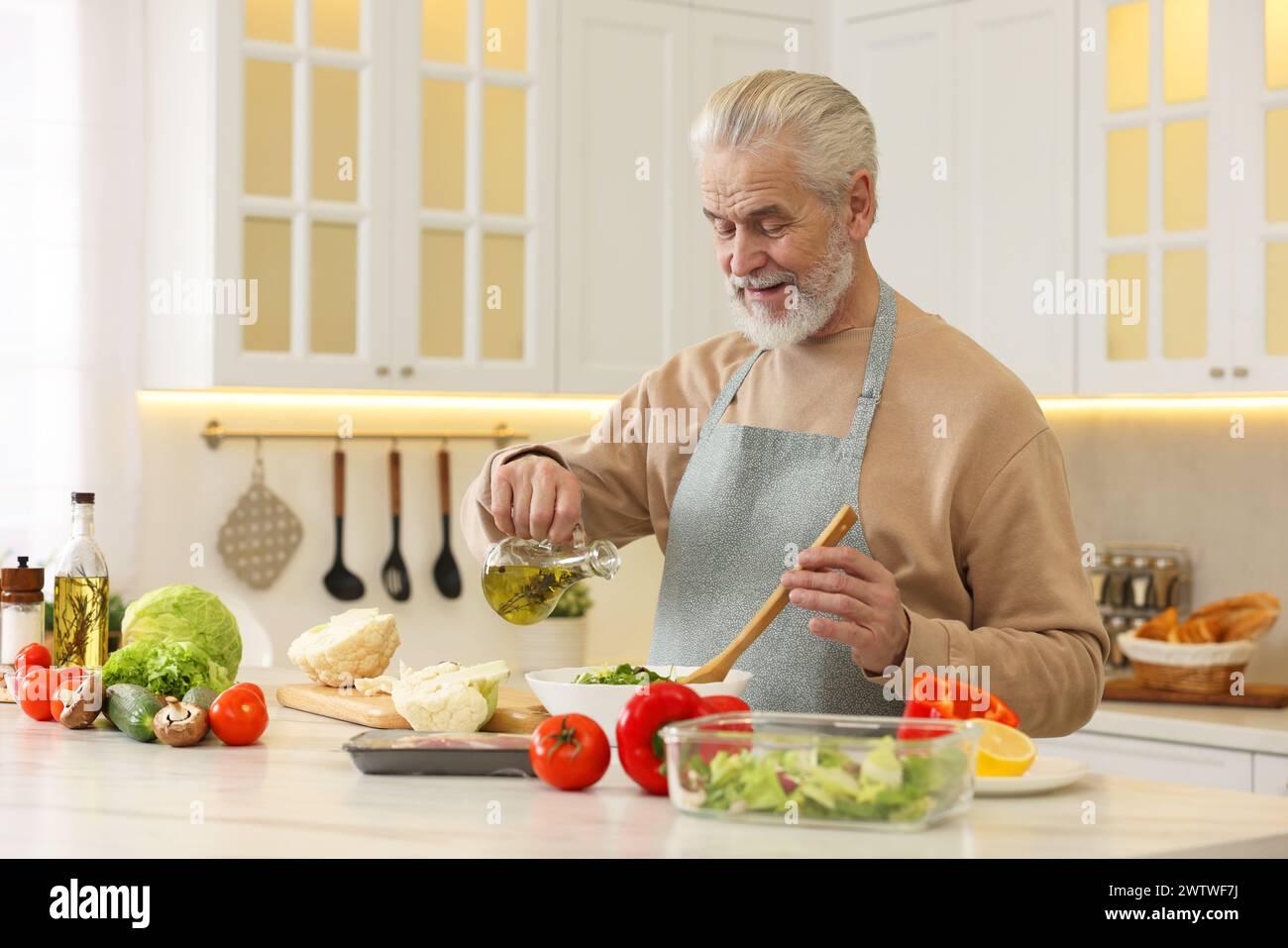 Senior man pouring kitchen hi-res stock photography and images - Alamy