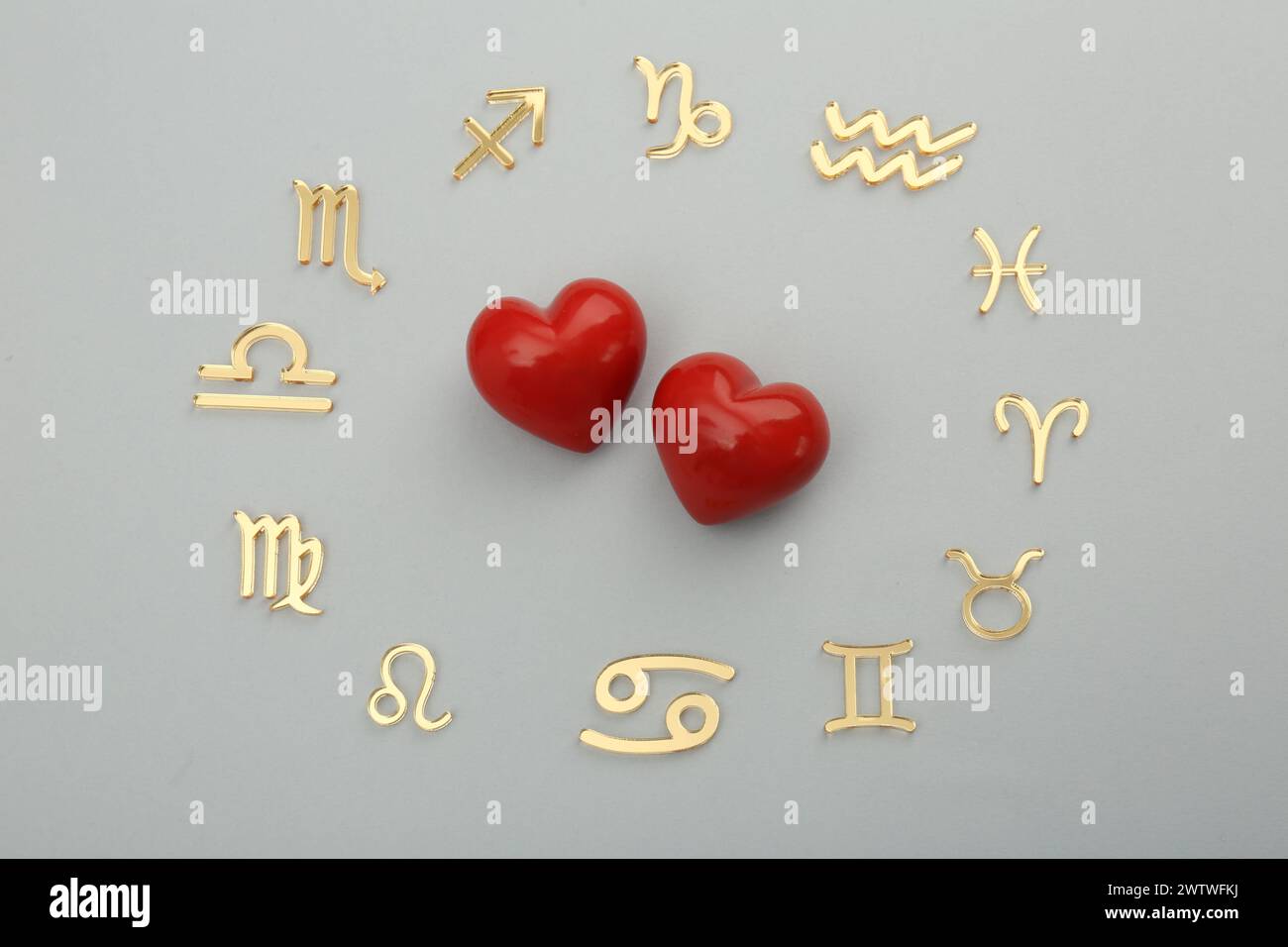 Zodiac signs and red hearts on grey background, flat lay Stock Photo ...