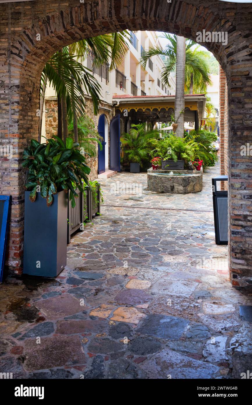 Idyllic view through an arched entrance to a tranquil courtyard with ...