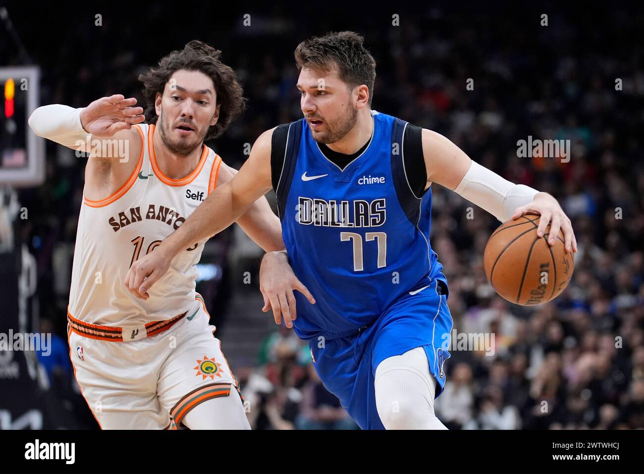 Dallas Mavericks guard Luka Doncic (77) drives around San Antonio Spurs ...