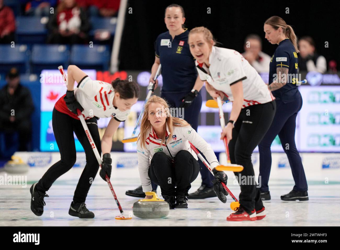 Denmark skip Madeleine Dupont, bottom center, watches her shot as ...