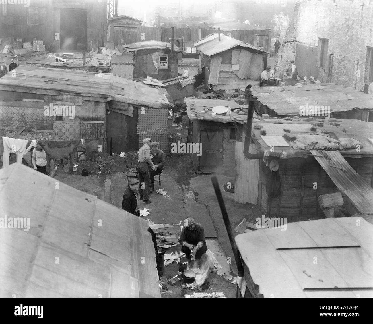 Overhead view of shacks in the slums, shantytown people cooking outside ...