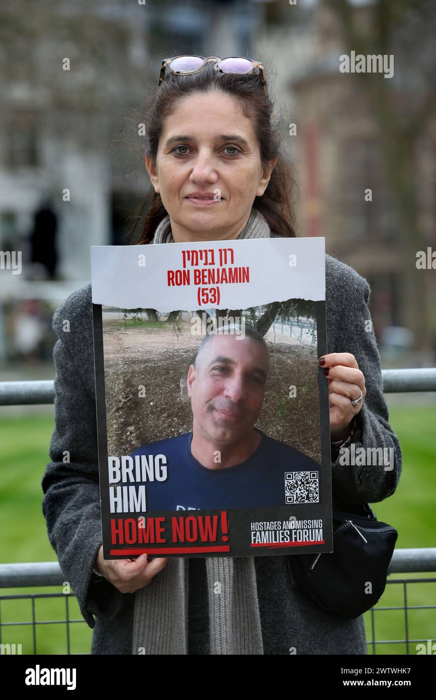 Jackie Benjamin holds up a poster of Ron Benjamin, her husbandís cousin ...
