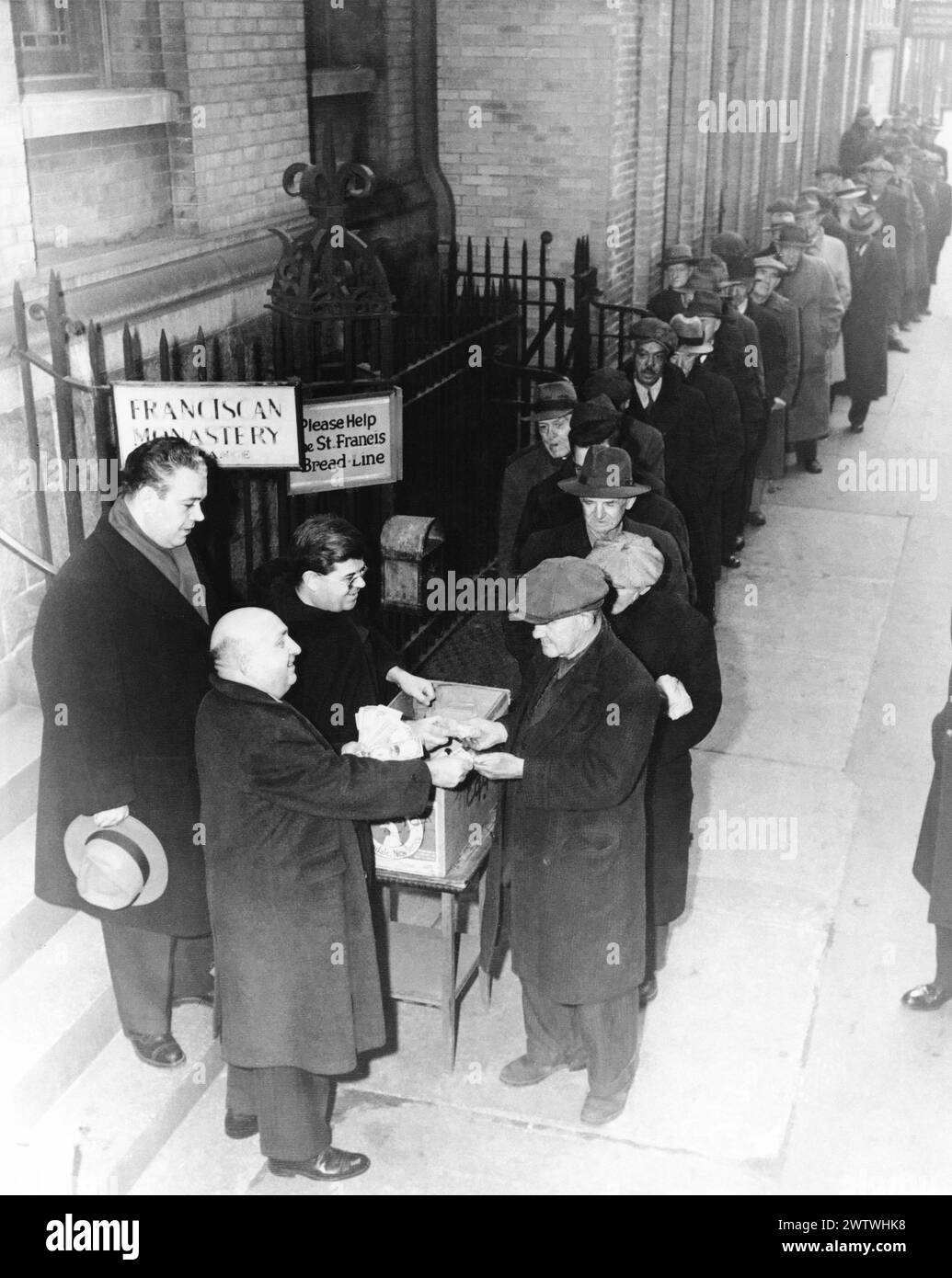 Joseph Snyder passing out bucks to a single line of well dressed men ...