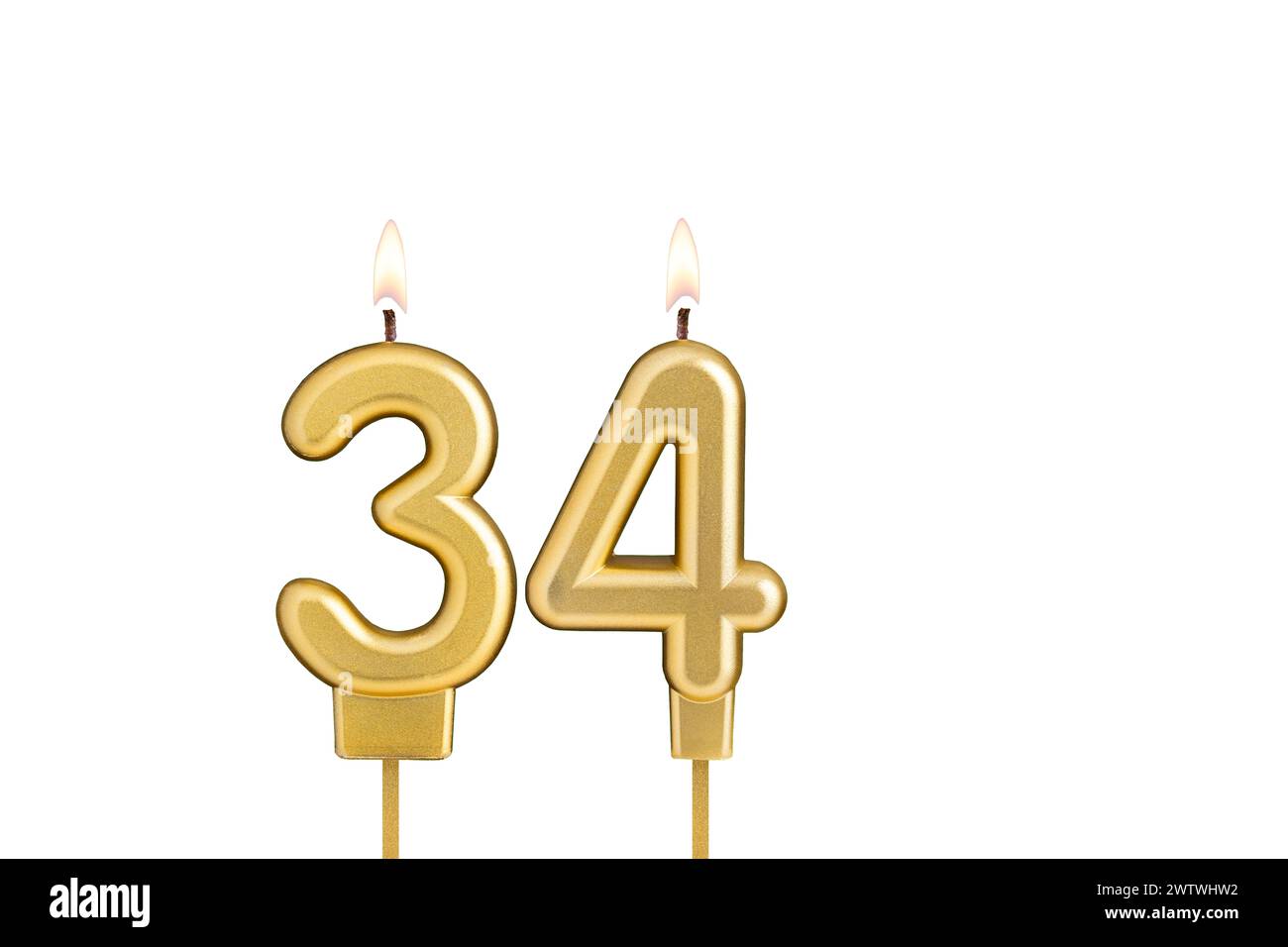 Golden number 34 birthday candle on white background Stock Photo - Alamy