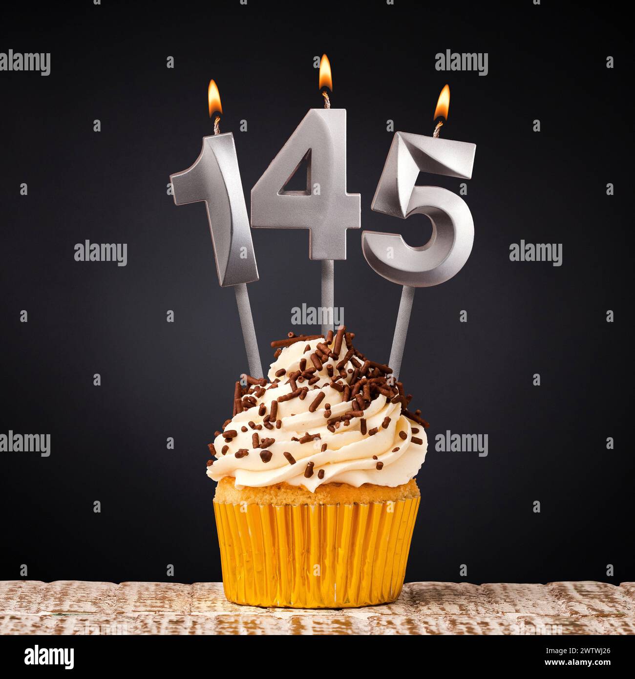 Birthday candle number 145 - Anniversary cupcake on black background ...