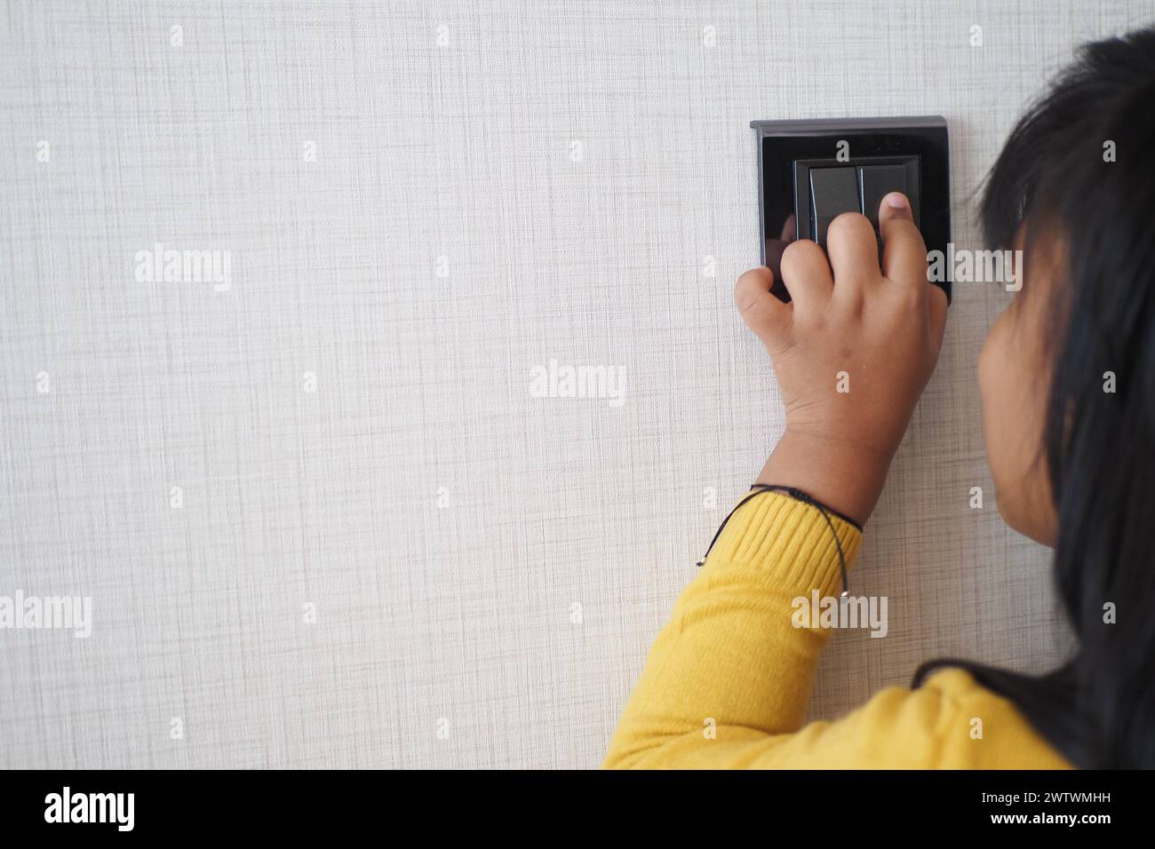 Child turning off light switch hi-res stock photography and images - Alamy