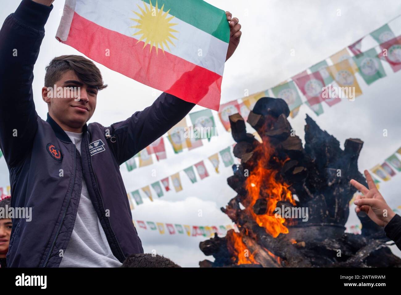 Batman, Turkey. 19th Mar, 2024. A young man waves a Kurdistan Regional ...
