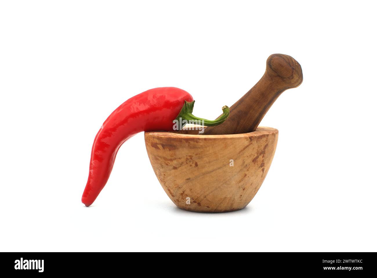Fresh red chili pepper and old rustic wooden pestle with mortar ...