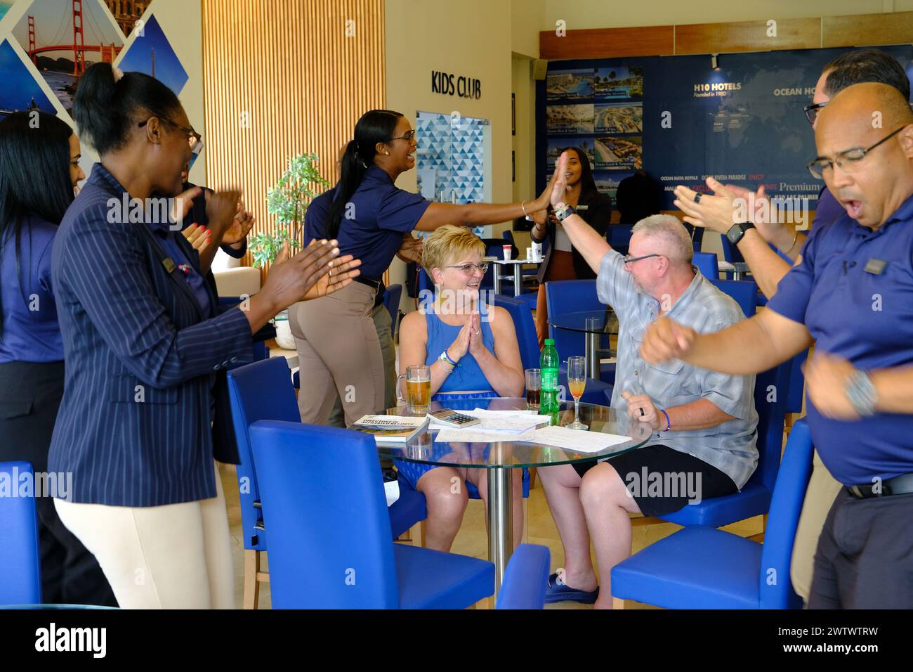 Sales team cheering with customers after a successful hotel club ...