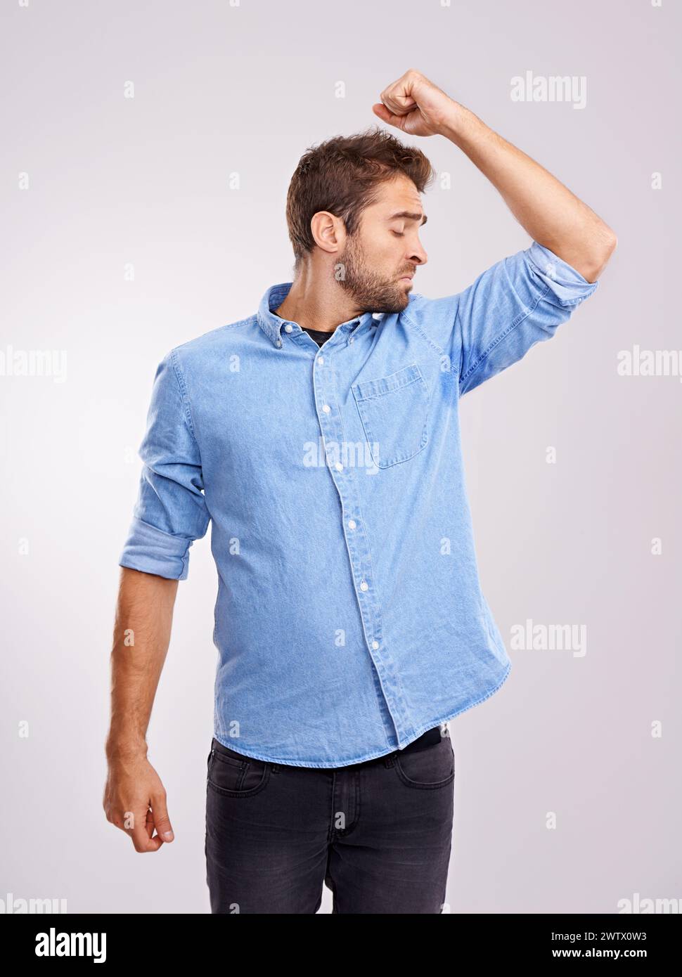 Man, smelling armpit and sweat stain, bad hygiene or body odor with ...