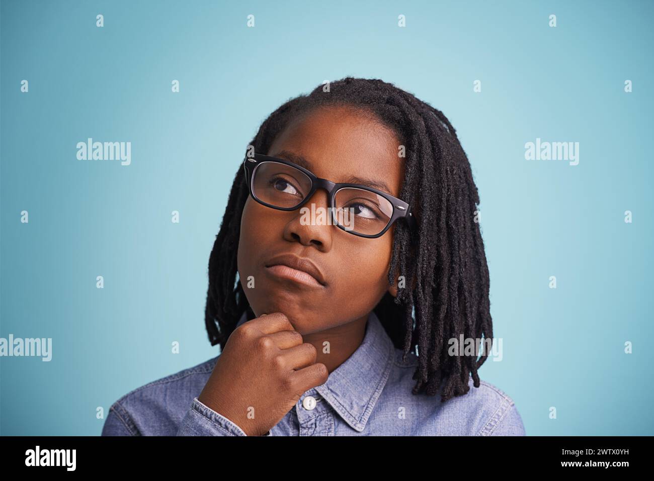 Thinking, glasses or black kid in studio with vision, solution or ...