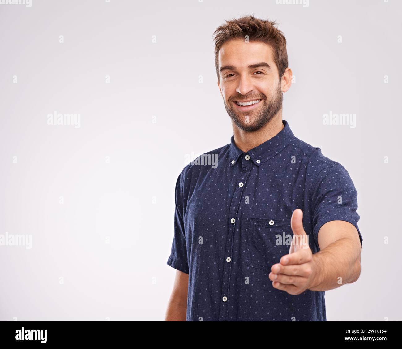Studio, portrait and welcome handshake from man in background or ...